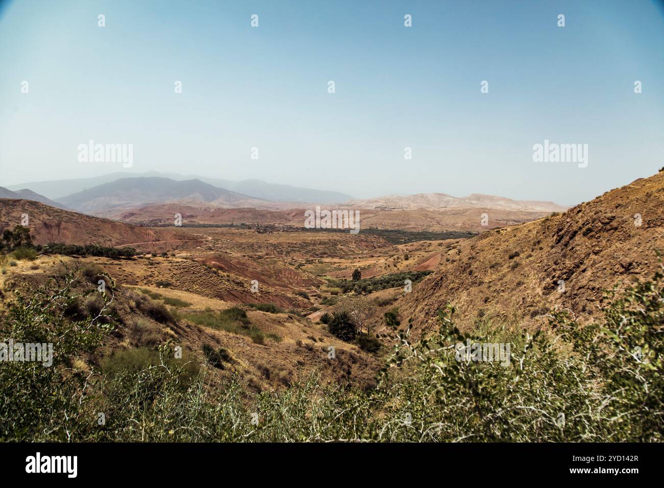 The sun shines brightly over the expansive badlands in Morocco ...