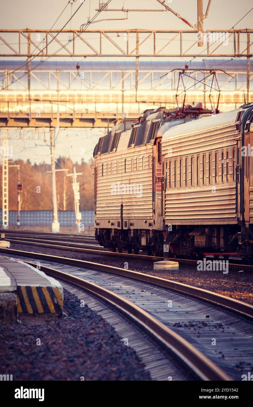 Locomotive rides on the Russian railway at sunset. Russian railway ...