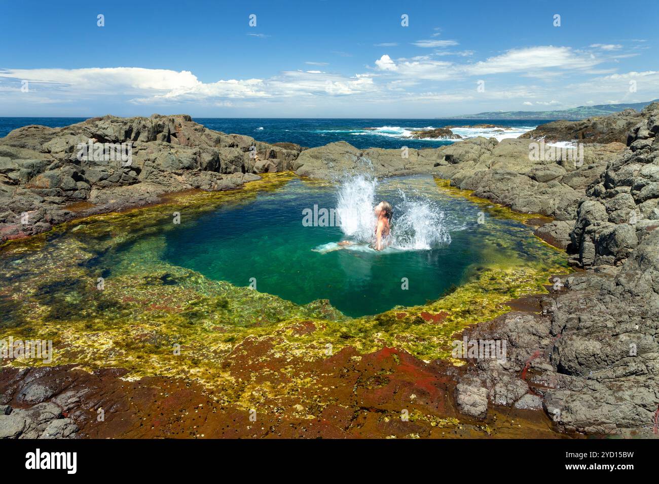 Woman making splash jumping into beautiful rock pool Stock Photo - Alamy