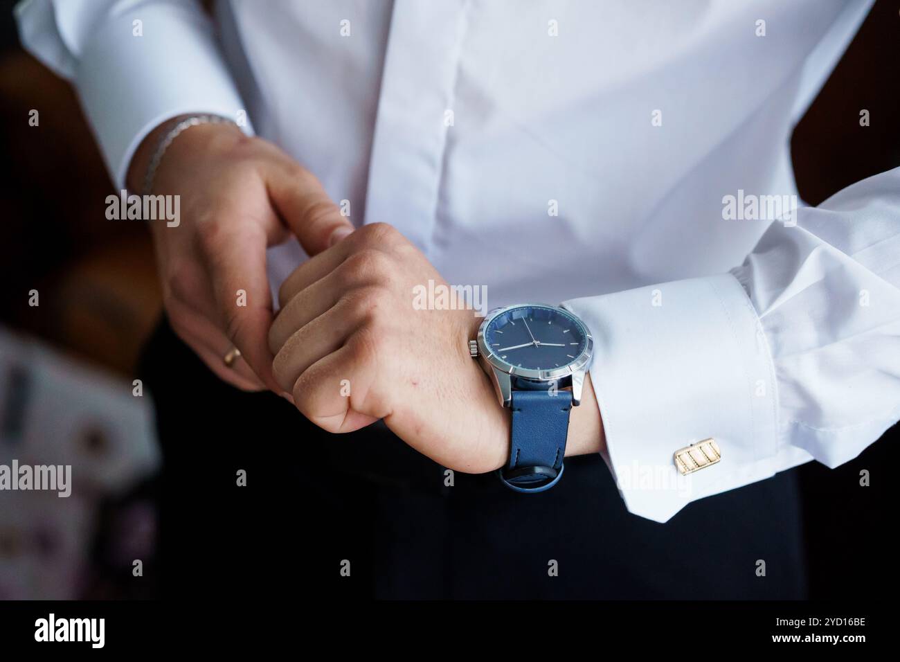 Elegant Man Adjusting His Watch in a Classic White Dress Shirt Stock ...