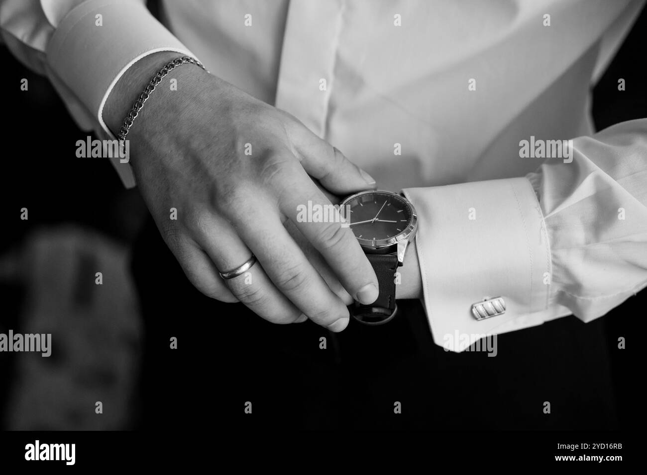 Elegant Groom Adjusting Watch in Formal Attire Stock Photo - Alamy