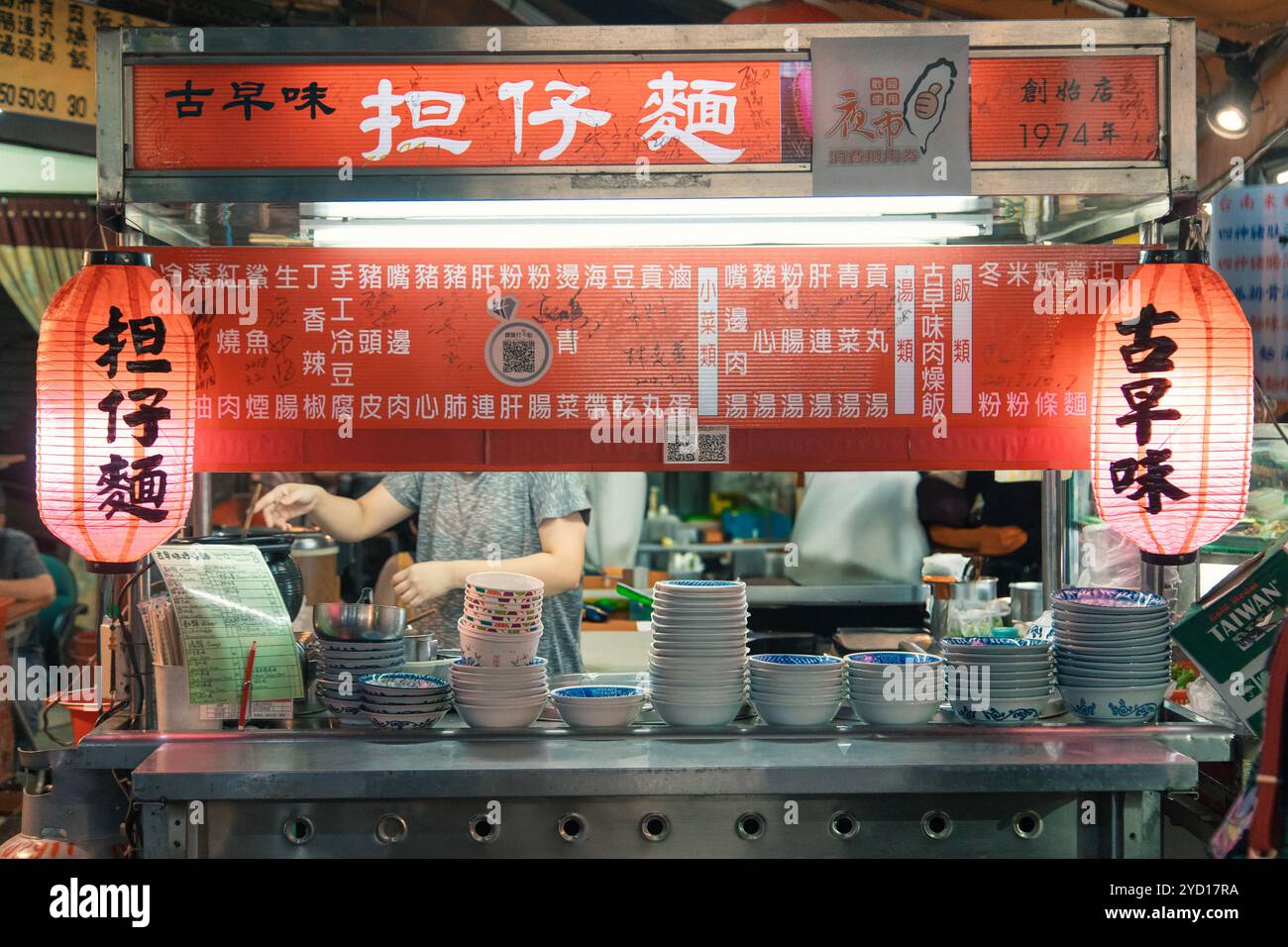 A bustling street food stall in Taipei showcases a colorful display of ...