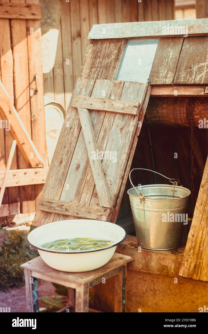 Iron bucket and well. Water from the ground Stock Photo - Alamy