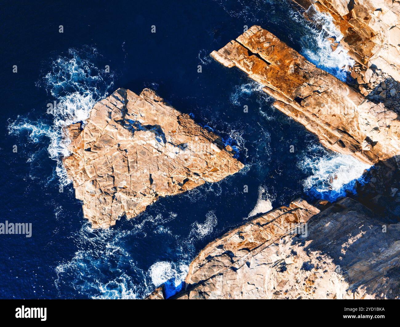 Shapely exposed rock slabs in deep water off the coast Stock Photo - Alamy