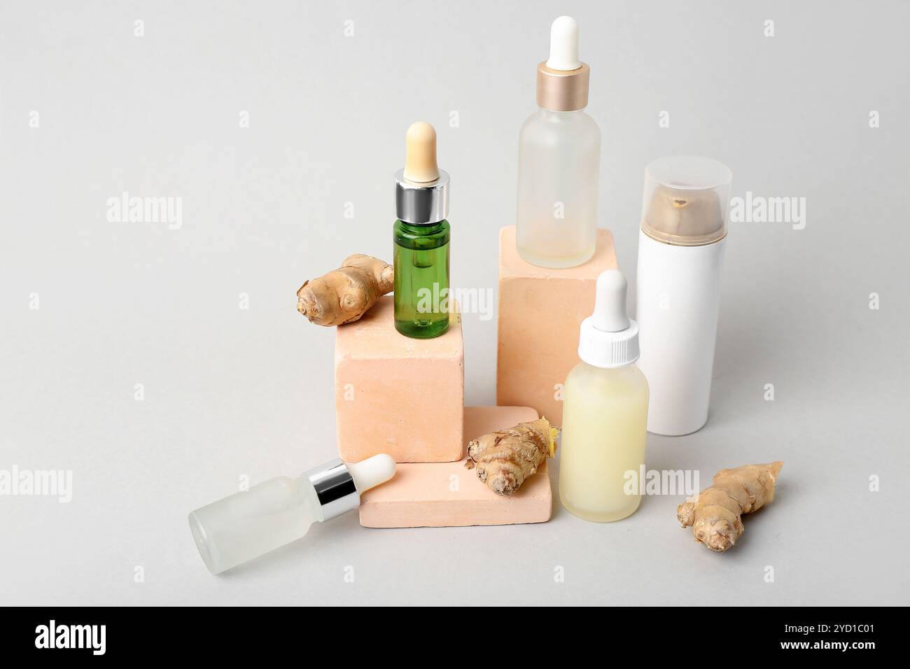 Composition with bottles of cosmetic products, ginger and plaster ...