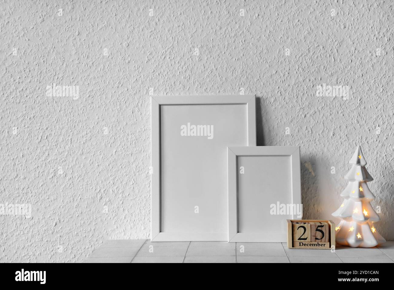 Beautiful blank photo frames, calendar and Christmas tree figure on ...