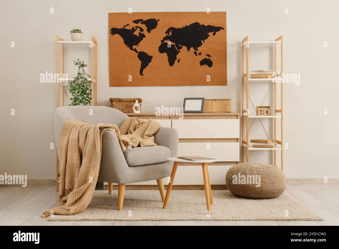 World map on wall, armchair, chest of drawers and shelving units in ...