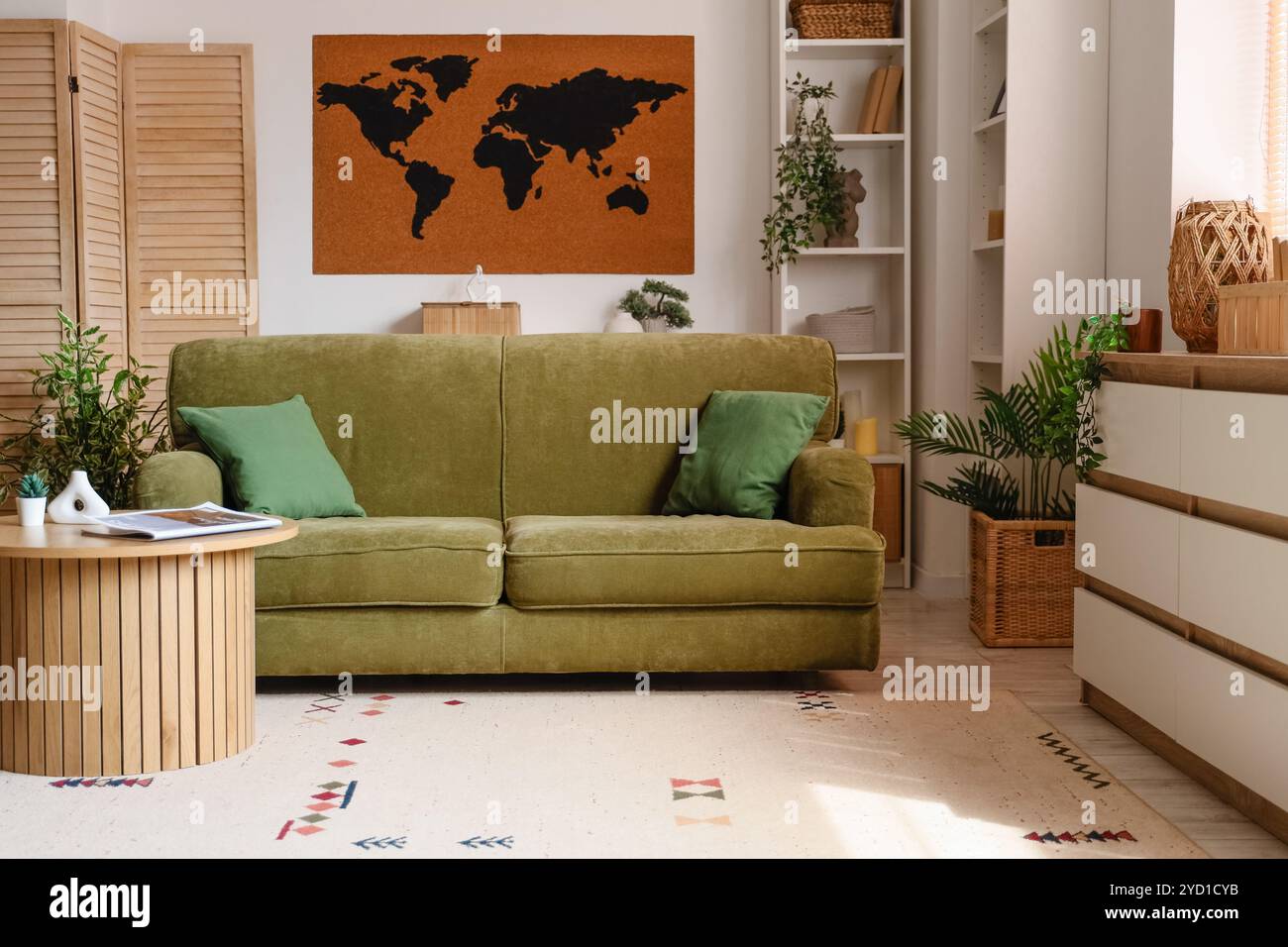 World map on wall, sofa, folding screen and table in interior of living ...