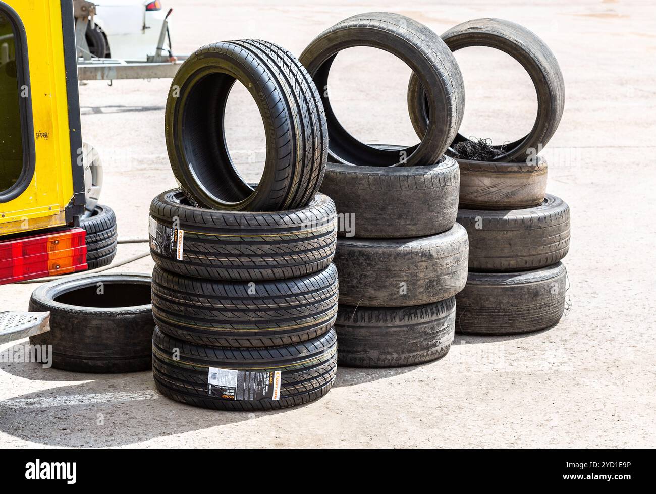 New and used car tires stacked on road Stock Photo - Alamy