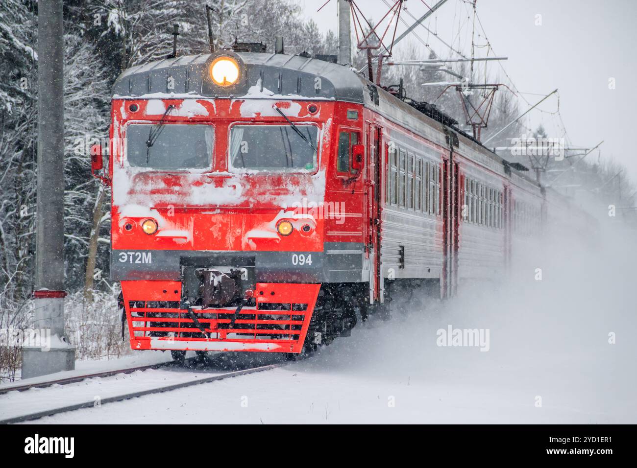 Russian train in the winter. The train rides by rail in the winter in ...