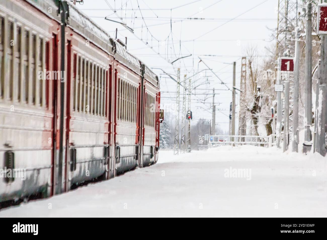 Russian train in the winter. The train on the platform. The train pulls ...