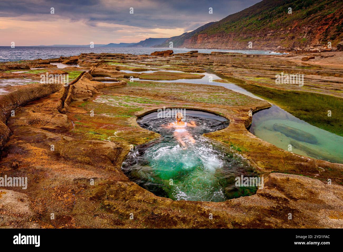 A woman enjoying a swim in the Figure 8 plunge pools. A set of rock ...