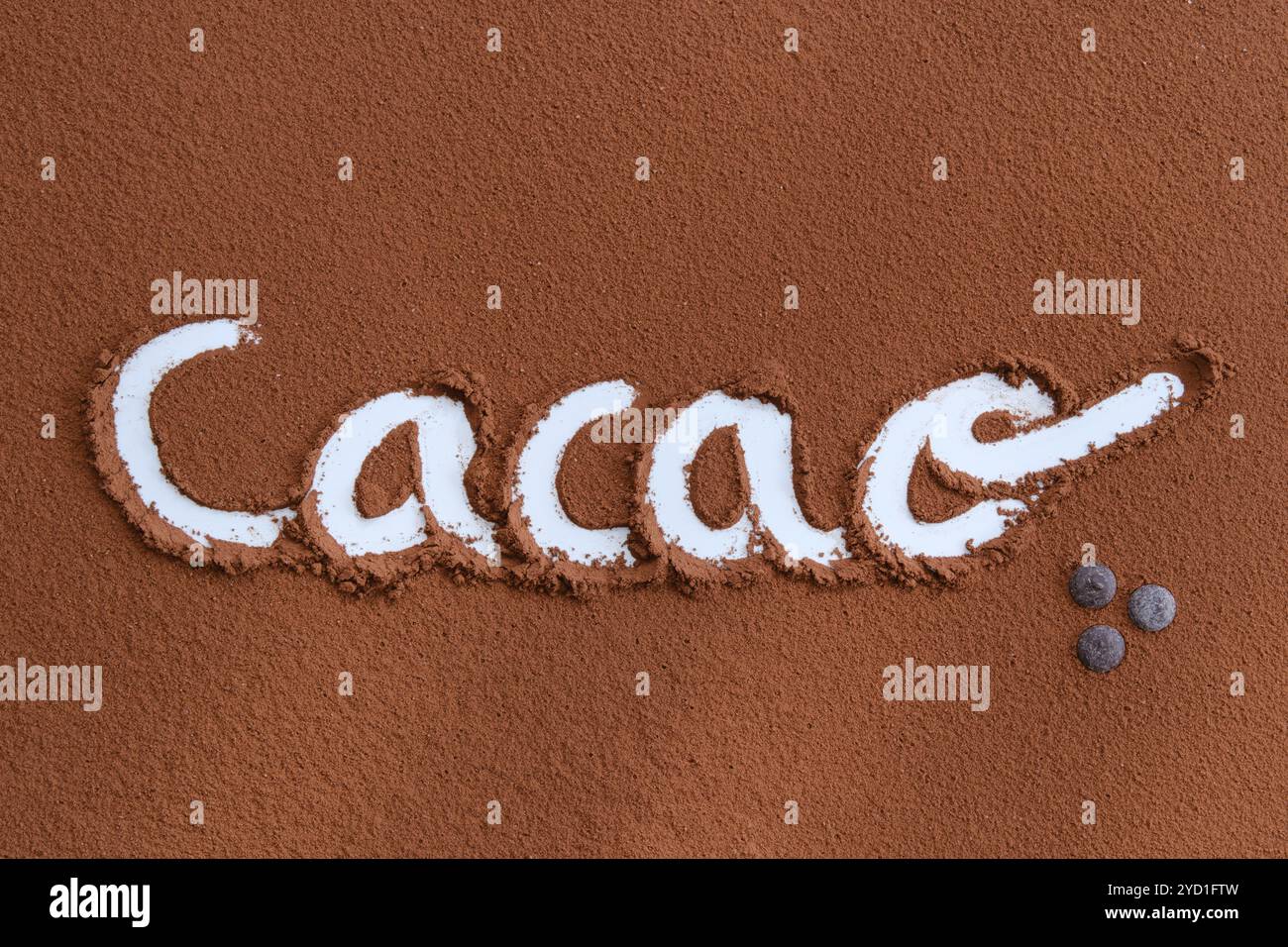 Word "Cacao" written in cocoa powder with chocolate chips on a textured ...