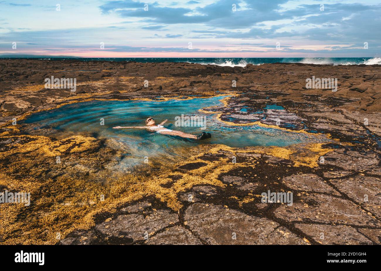 Female leisurely floating in a rock pool by the ocean Stock Photo - Alamy