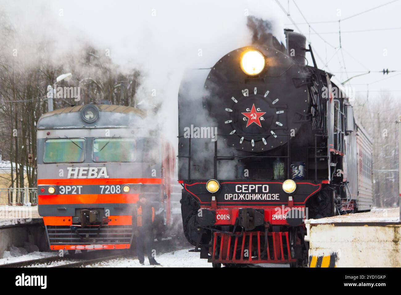 Old locomotive rides by rail in winter. Public transport. Passenger ...