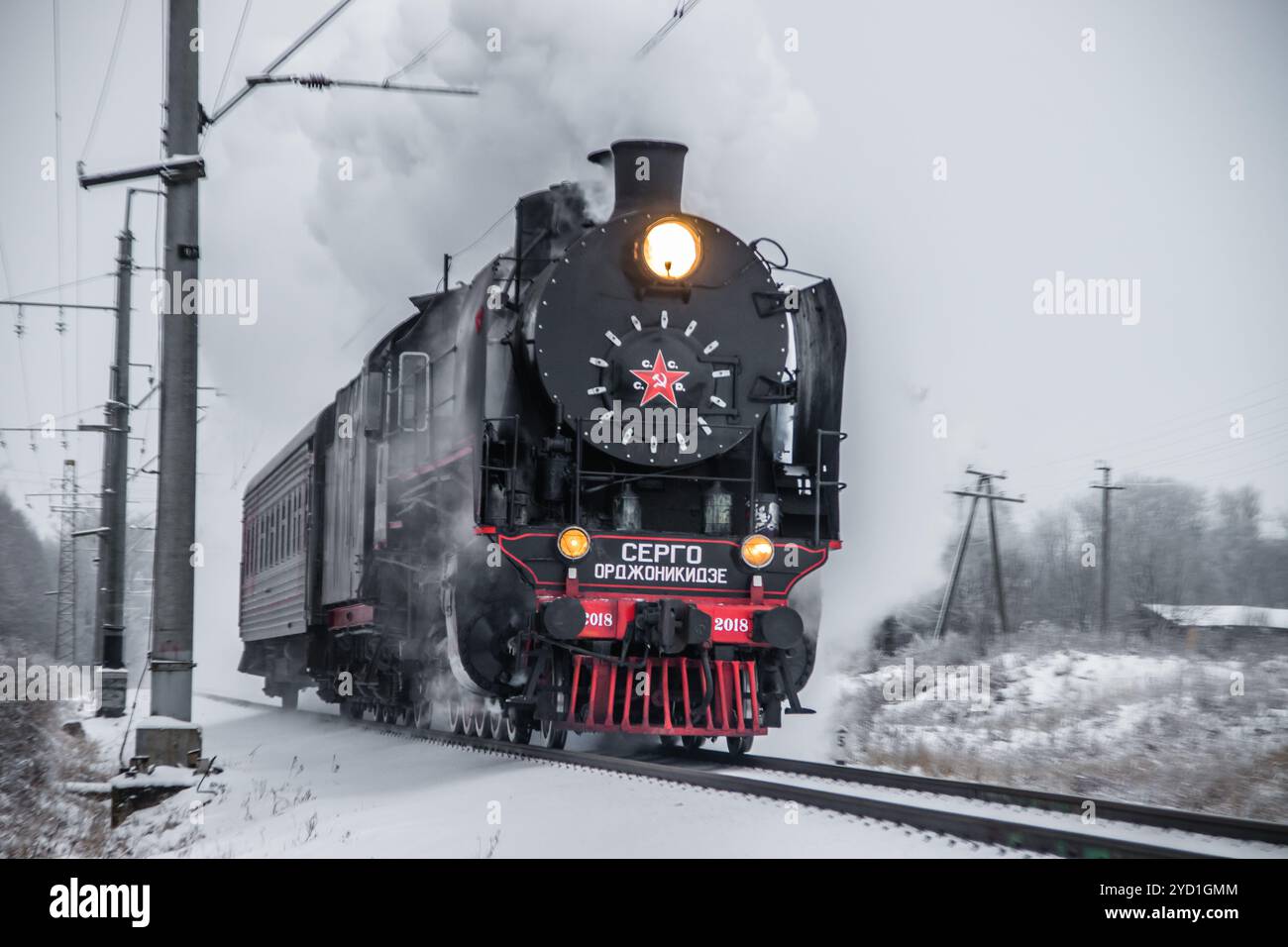 Old locomotive rides by rail in winter. Public transport. Passenger ...