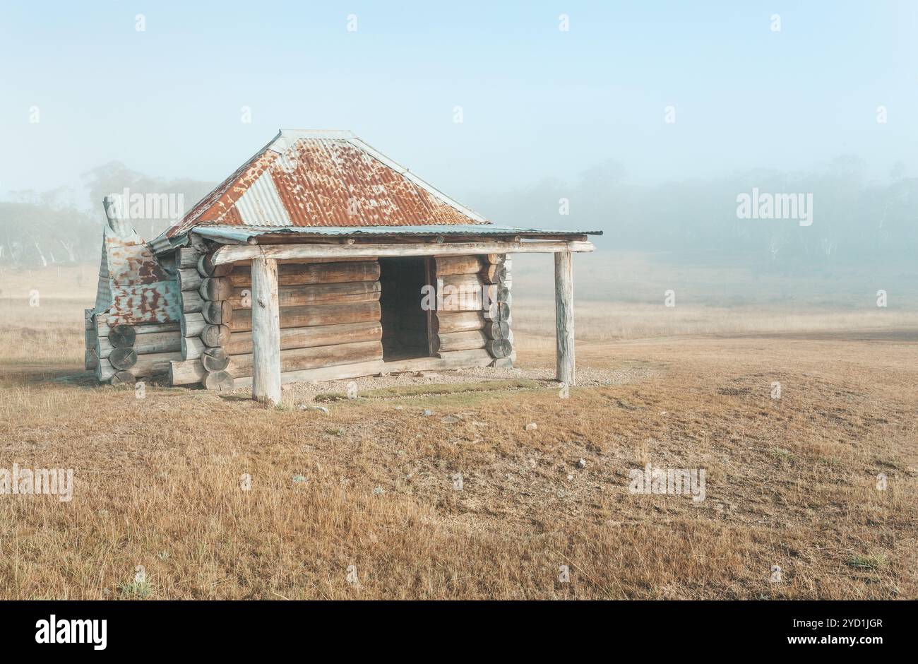 Log cabin in the morning mist Stock Photo - Alamy