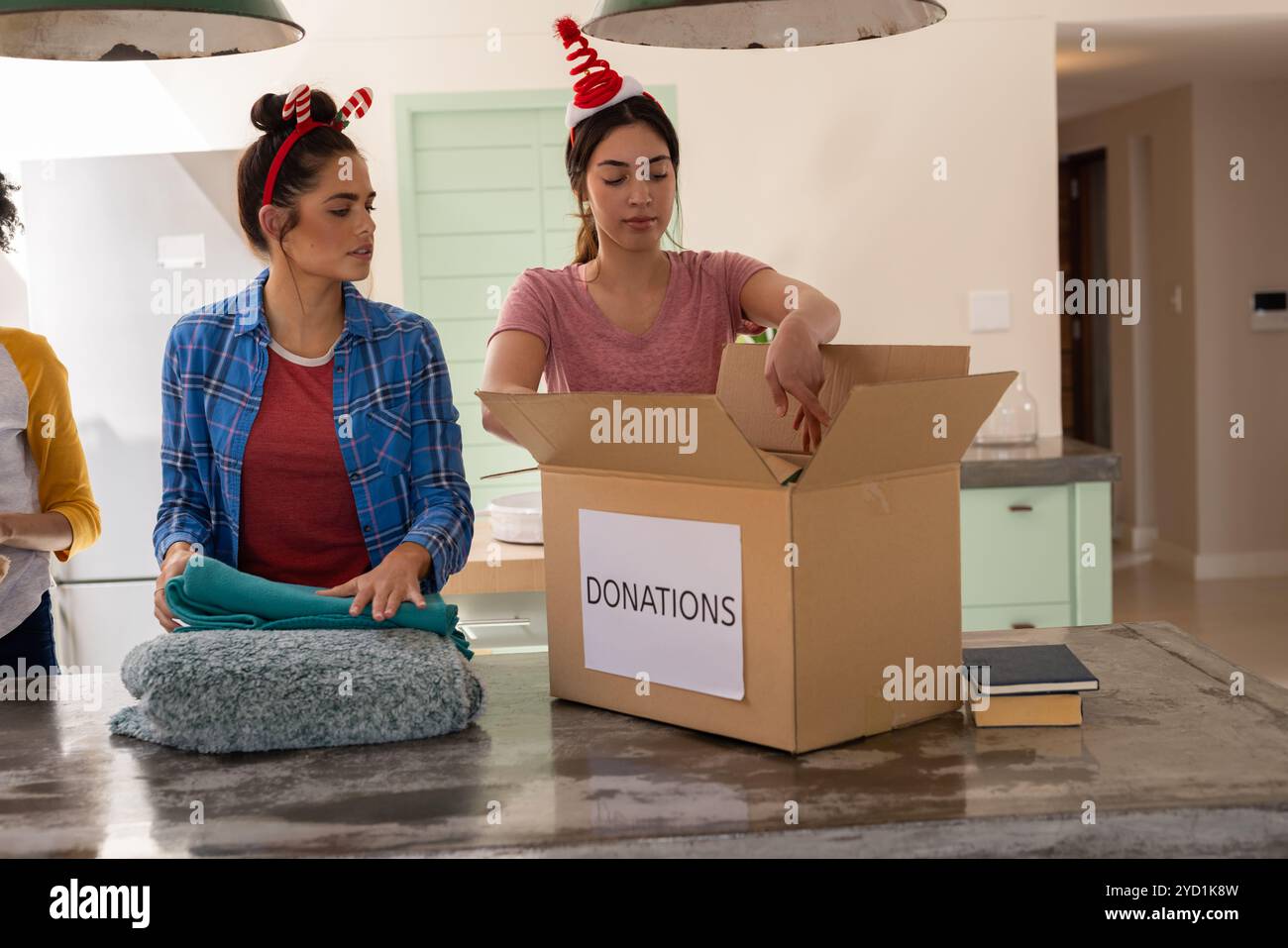 Christmas time, packing donations in box, multiracial female friends at ...