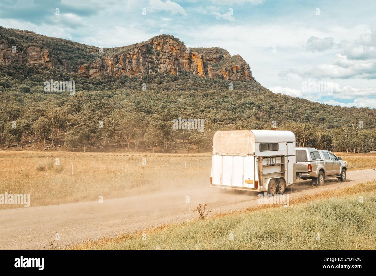 Horse float pulled by four wheel drive along a dirt road, dry dust ...