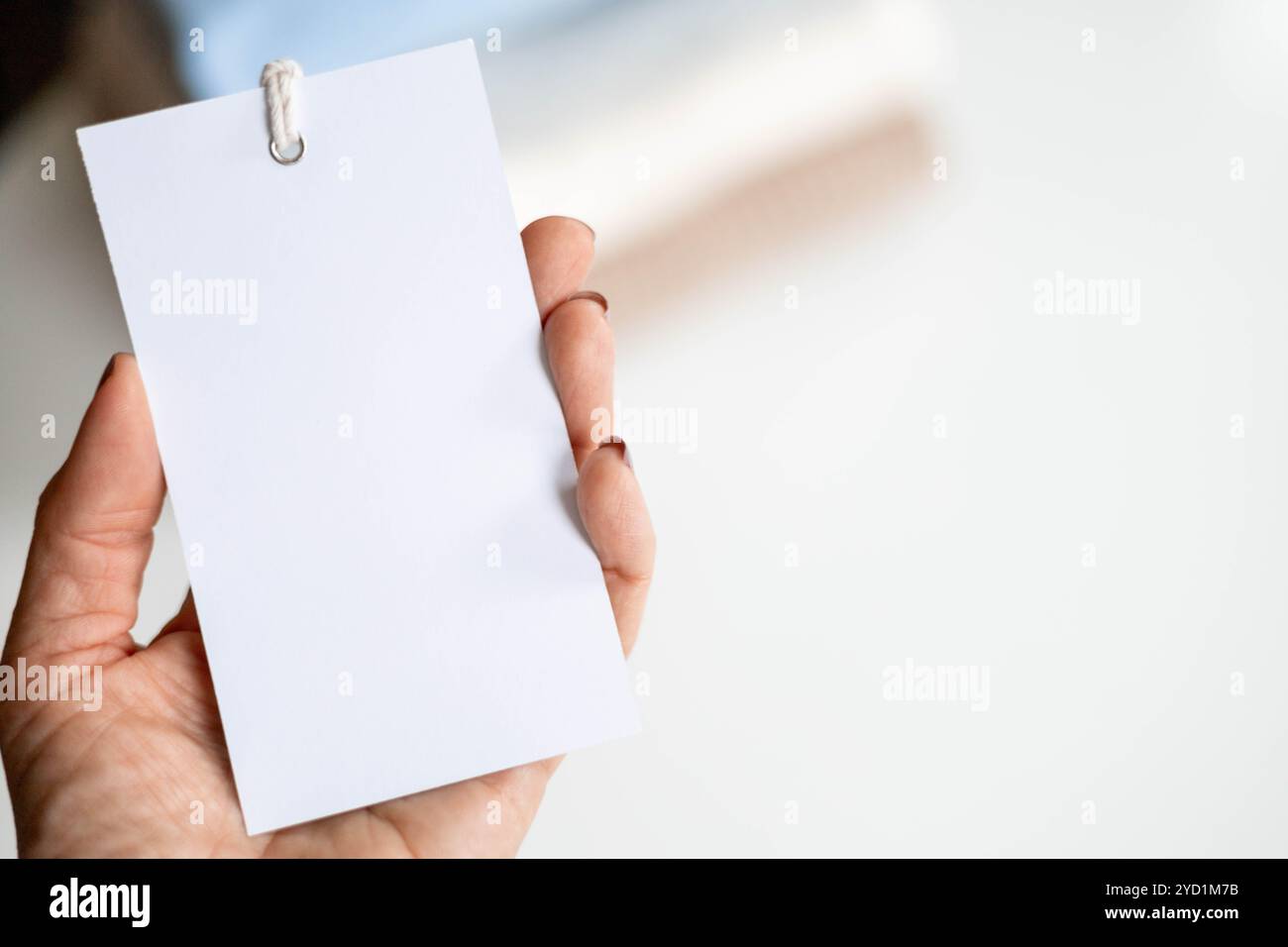 Hand holding blank white label on clean white background Stock Photo ...
