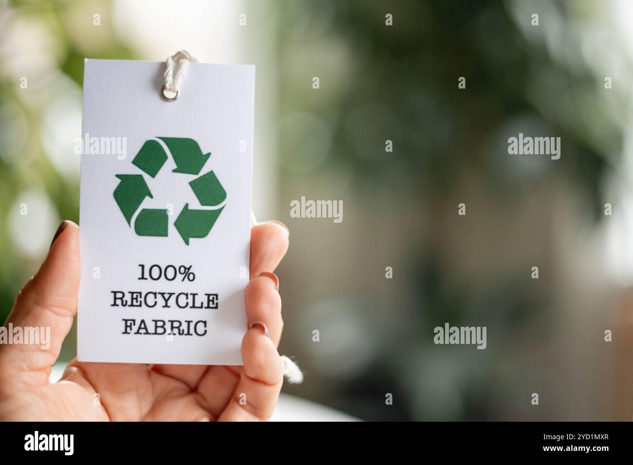 Recyclable product concept. Hand takes a label with the words 100 ...