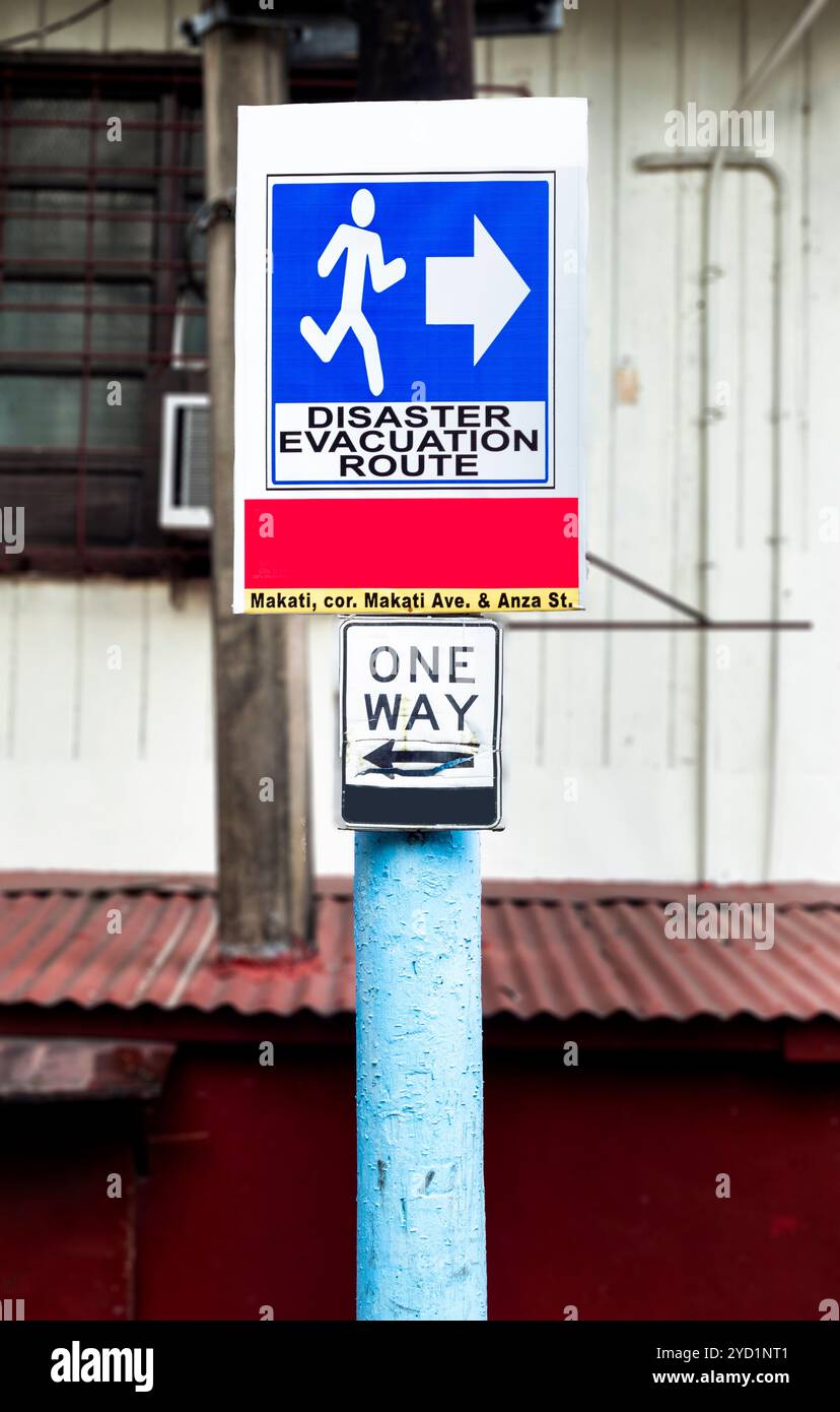 A signpost displaying directions and emergency information,in bold blue ...