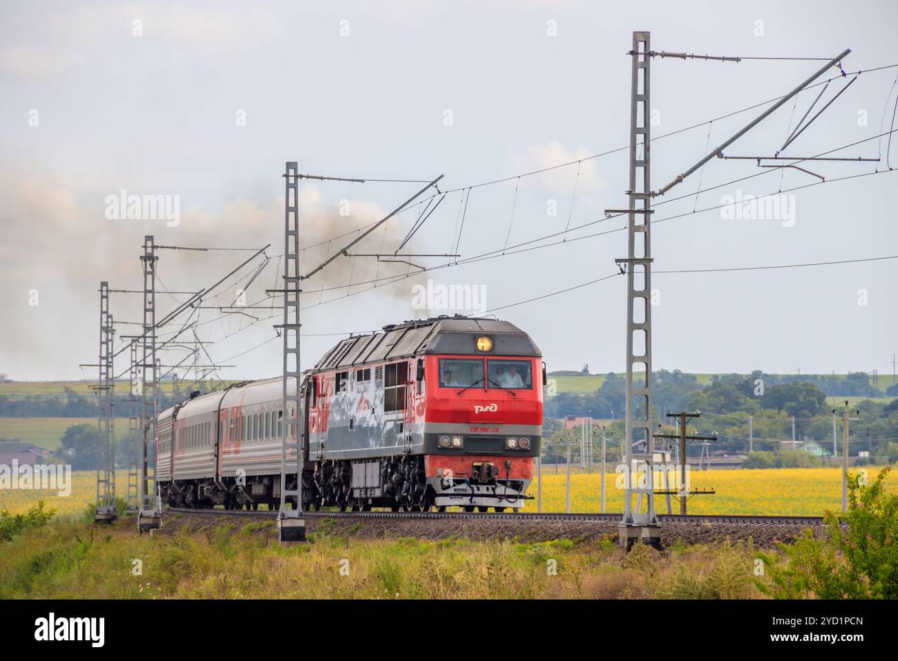 The Russian train travels by rail. Passenger train rides through the ...