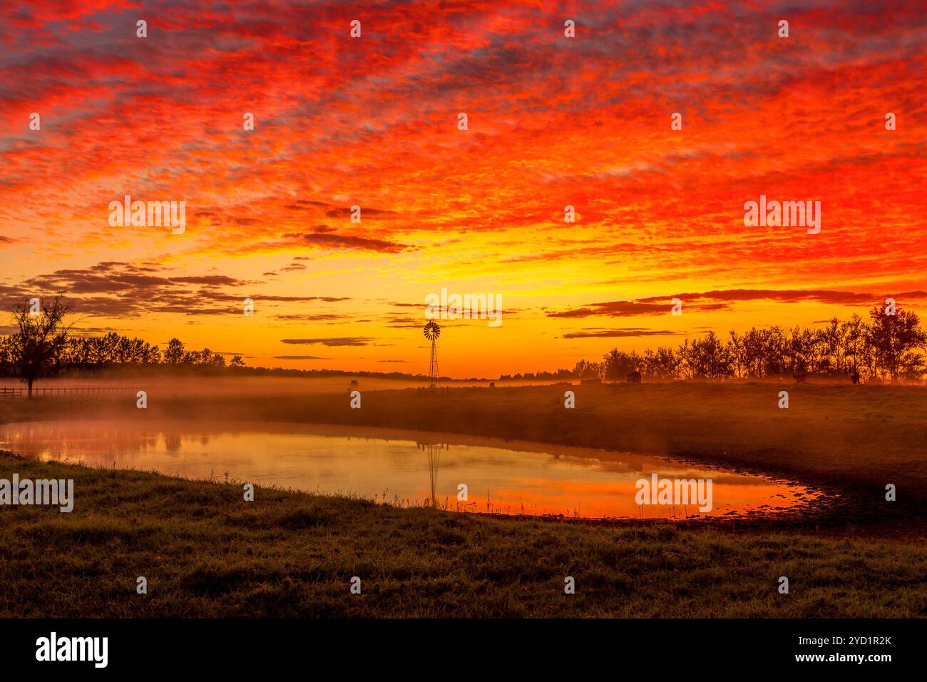 Blazing red sunrise skies across rural landscape Australia Stock Photo ...