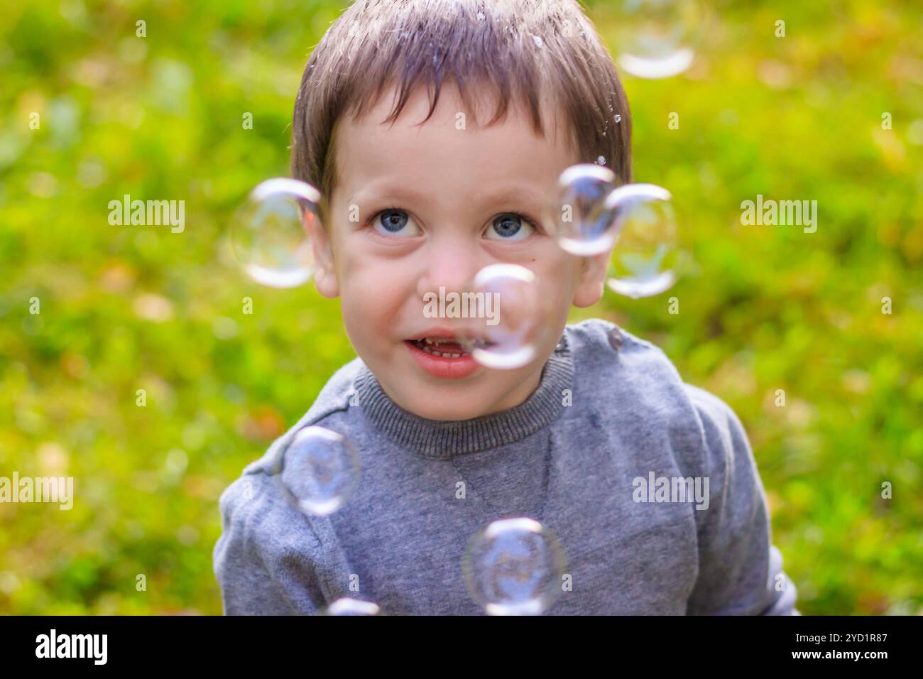 Beautiful boy blowing soap bubbles hi-res stock photography and images - Alamy