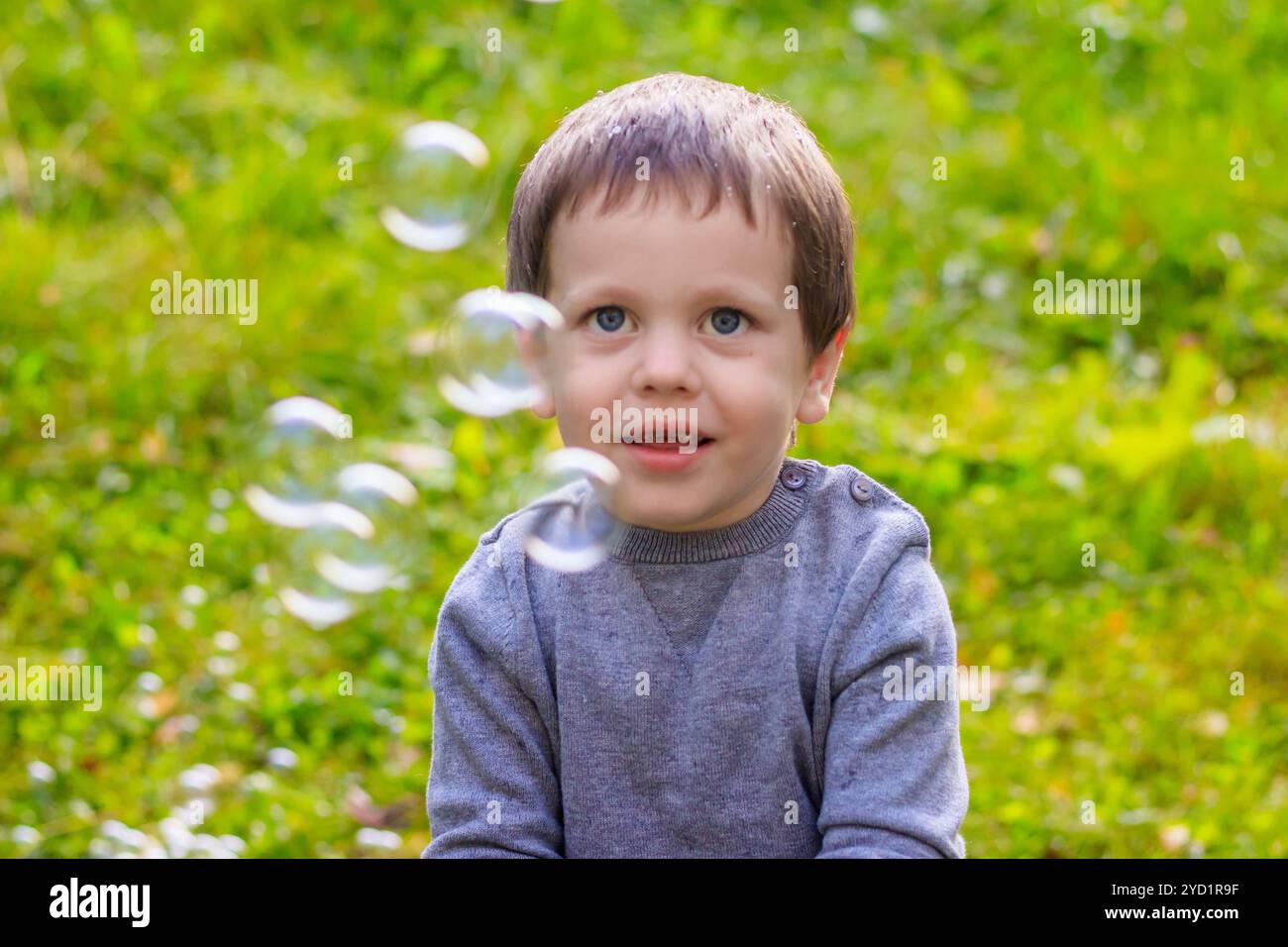 Beautiful boy blowing soap bubbles hi-res stock photography and images ...
