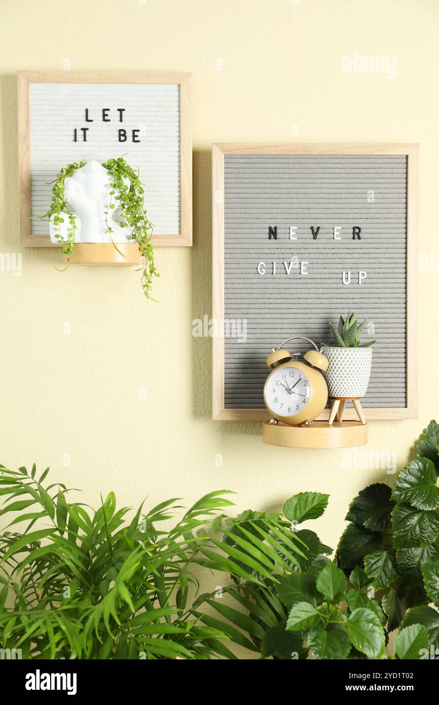 Letter boards with phrases Let It Be, Never Give Up, alarm clock and ...