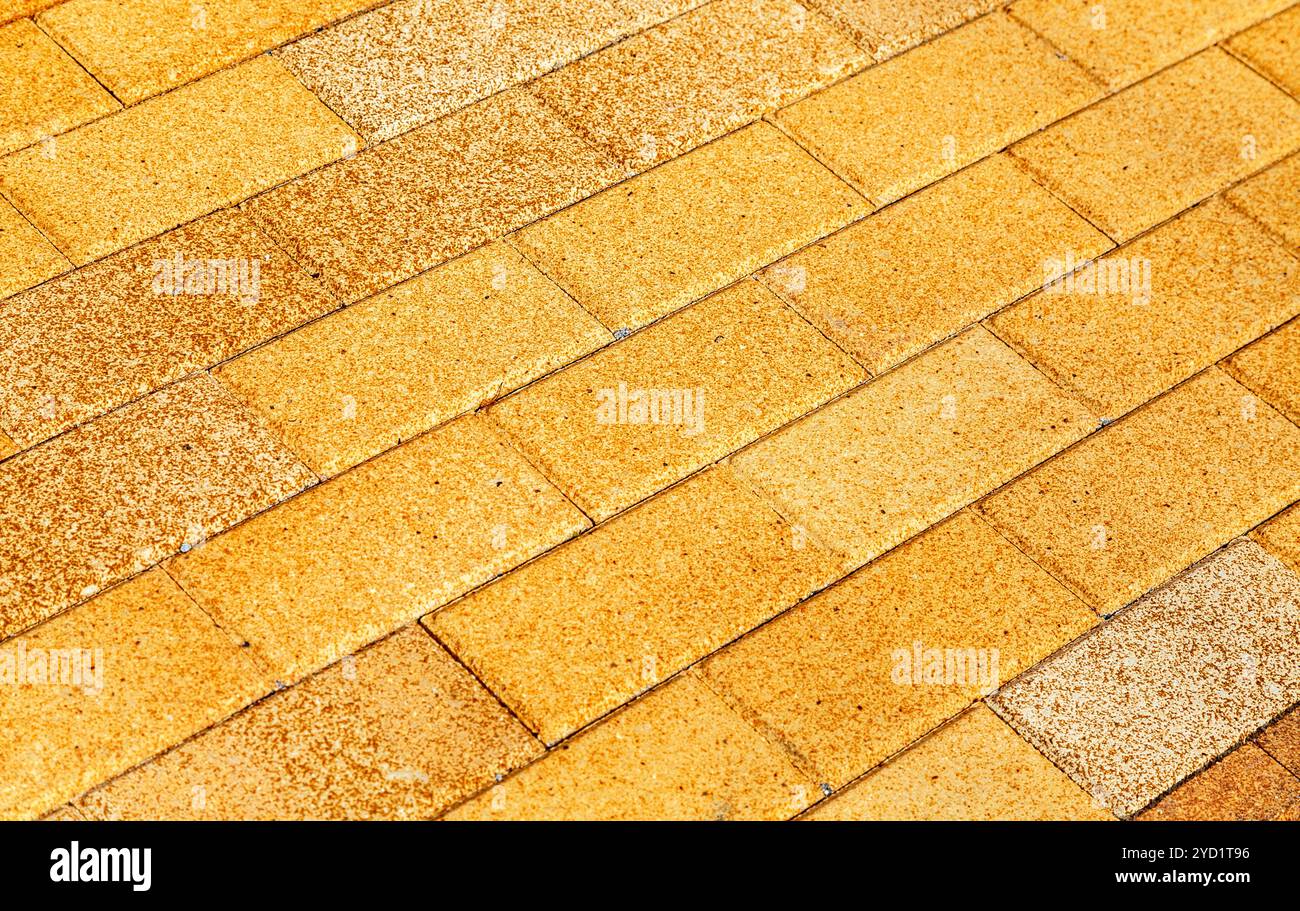 Yellow ceramic paving stones as background texture Stock Photo - Alamy