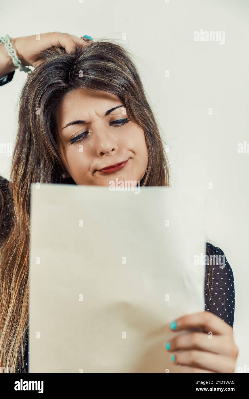 Confused woman reading document, scratching head, questioning ...