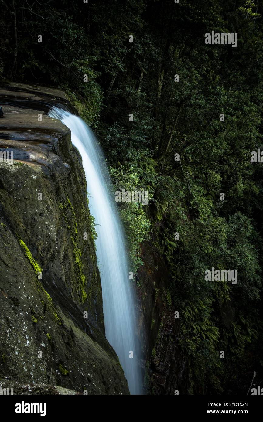 Cascading waters flow off tall cliffs Stock Photo - Alamy