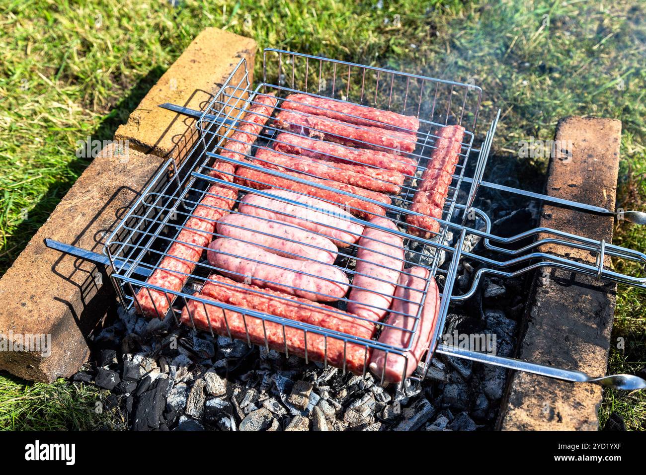 Delicious sausages from meat on a metal grid Stock Photo - Alamy