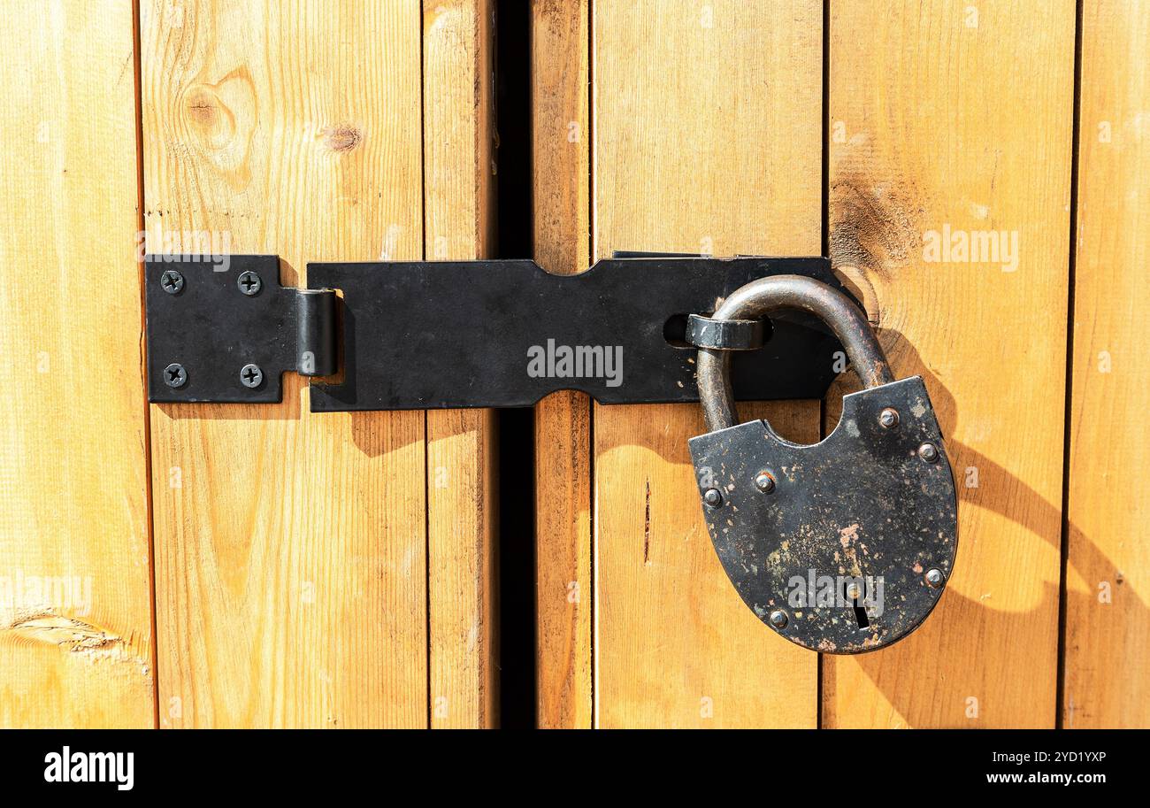 Massive wooden gate with padlock Stock Photo - Alamy