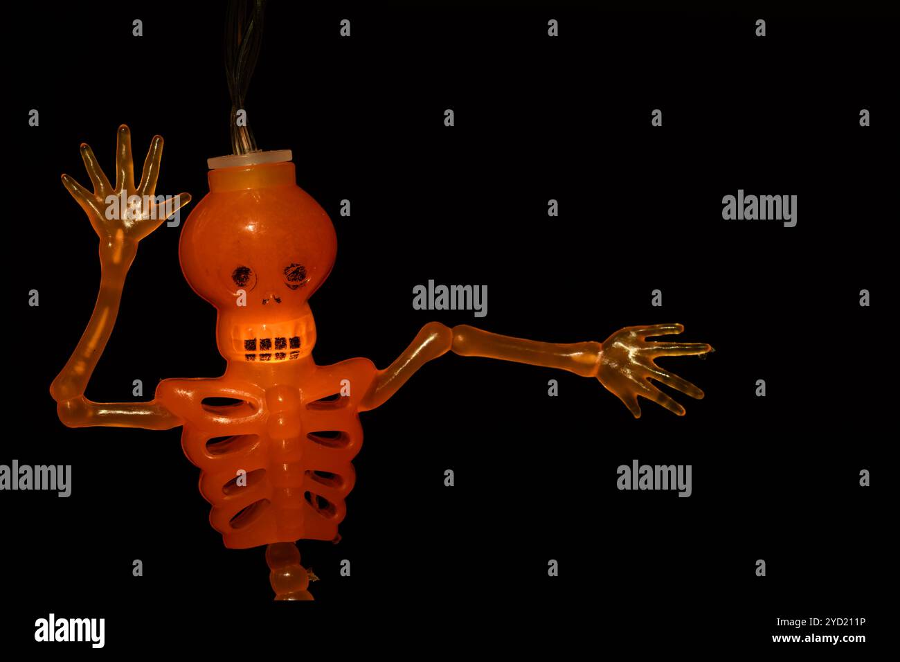 Plastic orange skeleton on the left side of a black background Stock ...