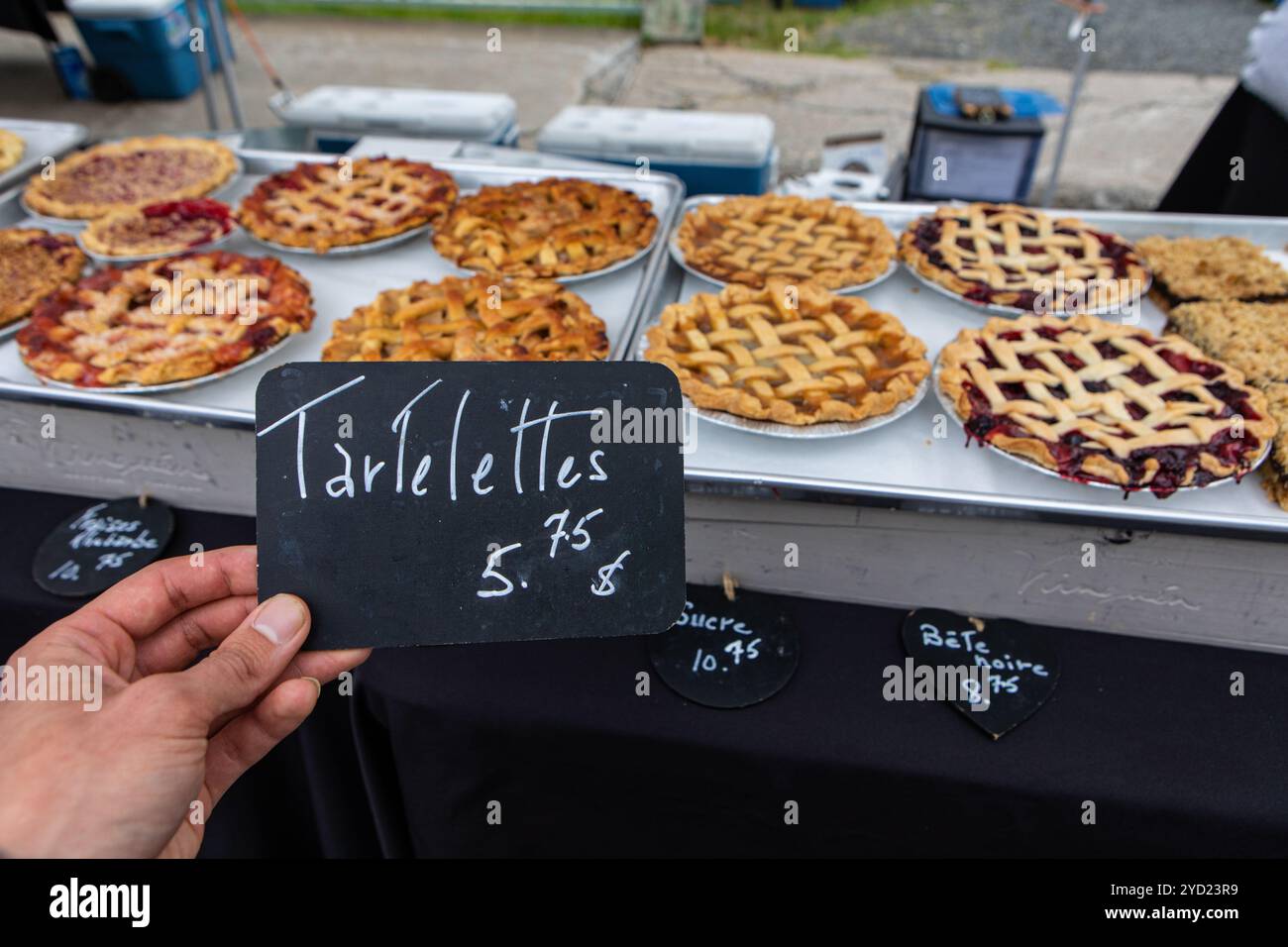 A person's hand is seen closeup holding a small French price tag ...