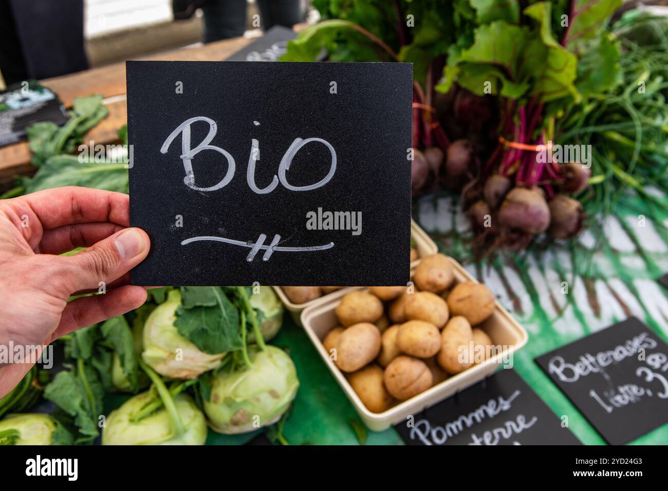 A first person perspective of a man holding a bio sign over trays of ...