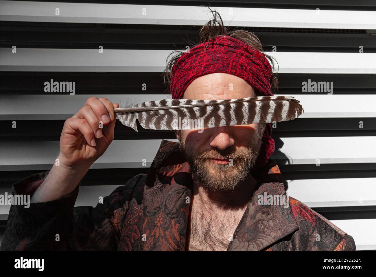 A closeup view of a poetic man wearing a red bandanna by modern ...
