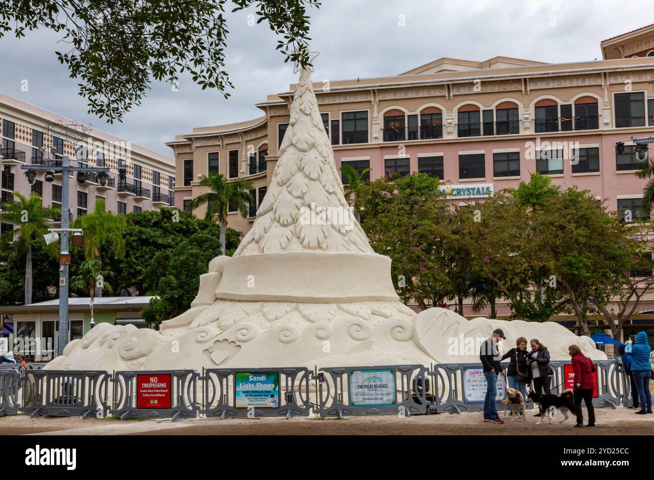 People and their dogs near a sand sculpture by Mark Mason and Team ...