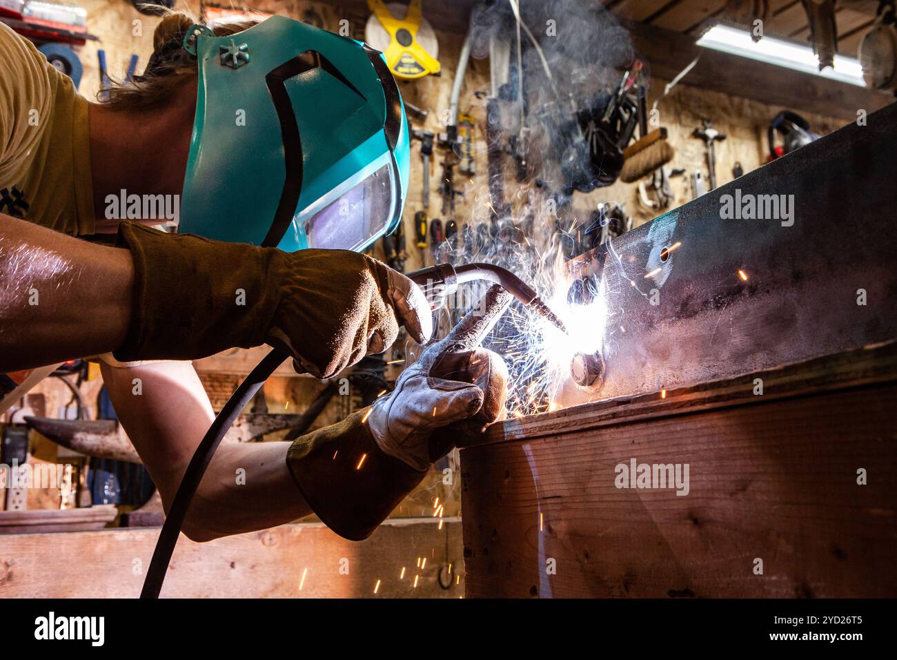 Blacksmith uses metal inert gas welder Stock Photo - Alamy