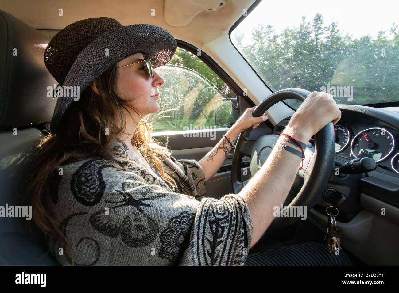 Caucasian woman driving SUV through the woods Stock Photo - Alamy