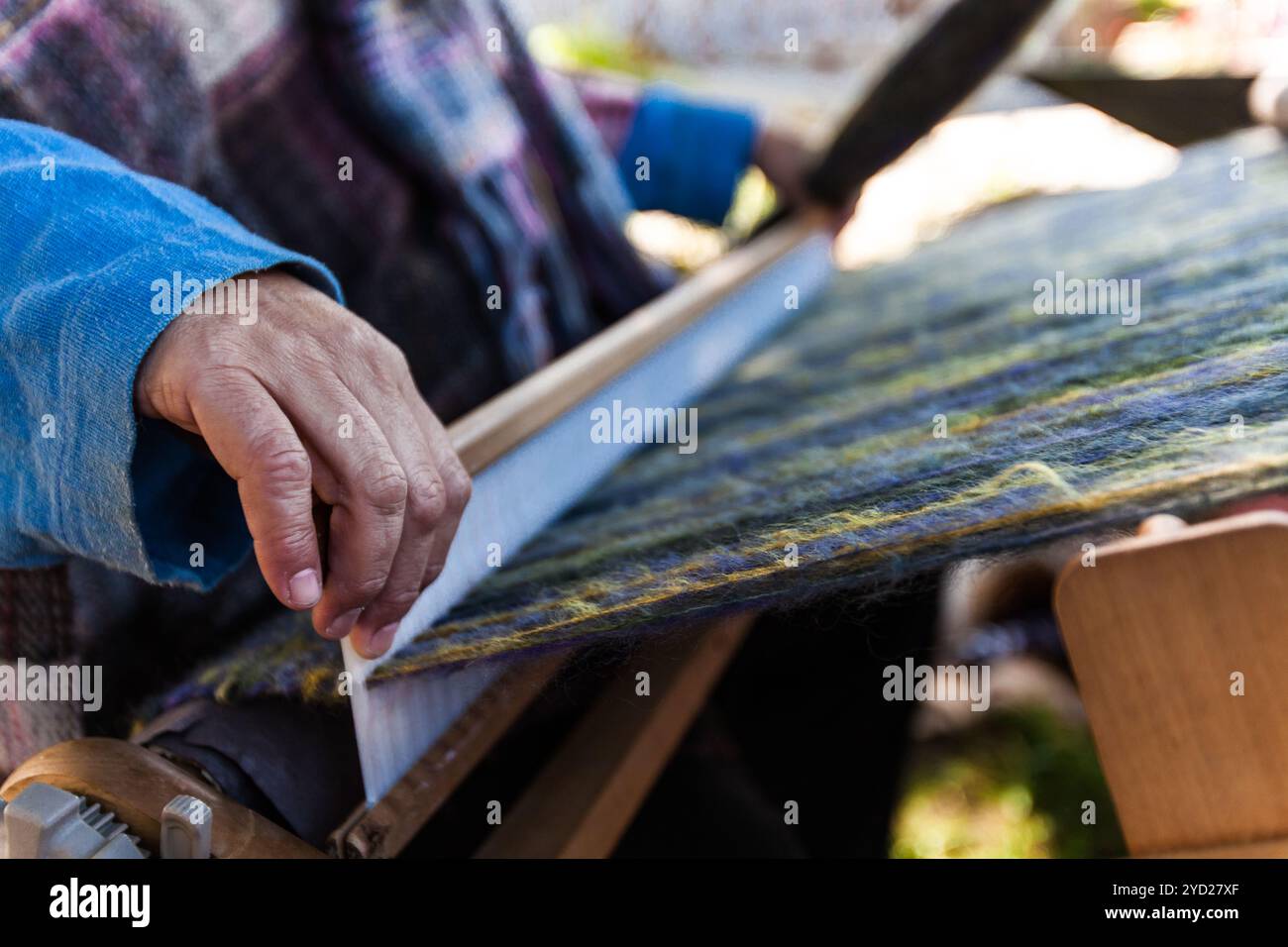 Man is weaving very fancy multi colored wool Stock Photo - Alamy