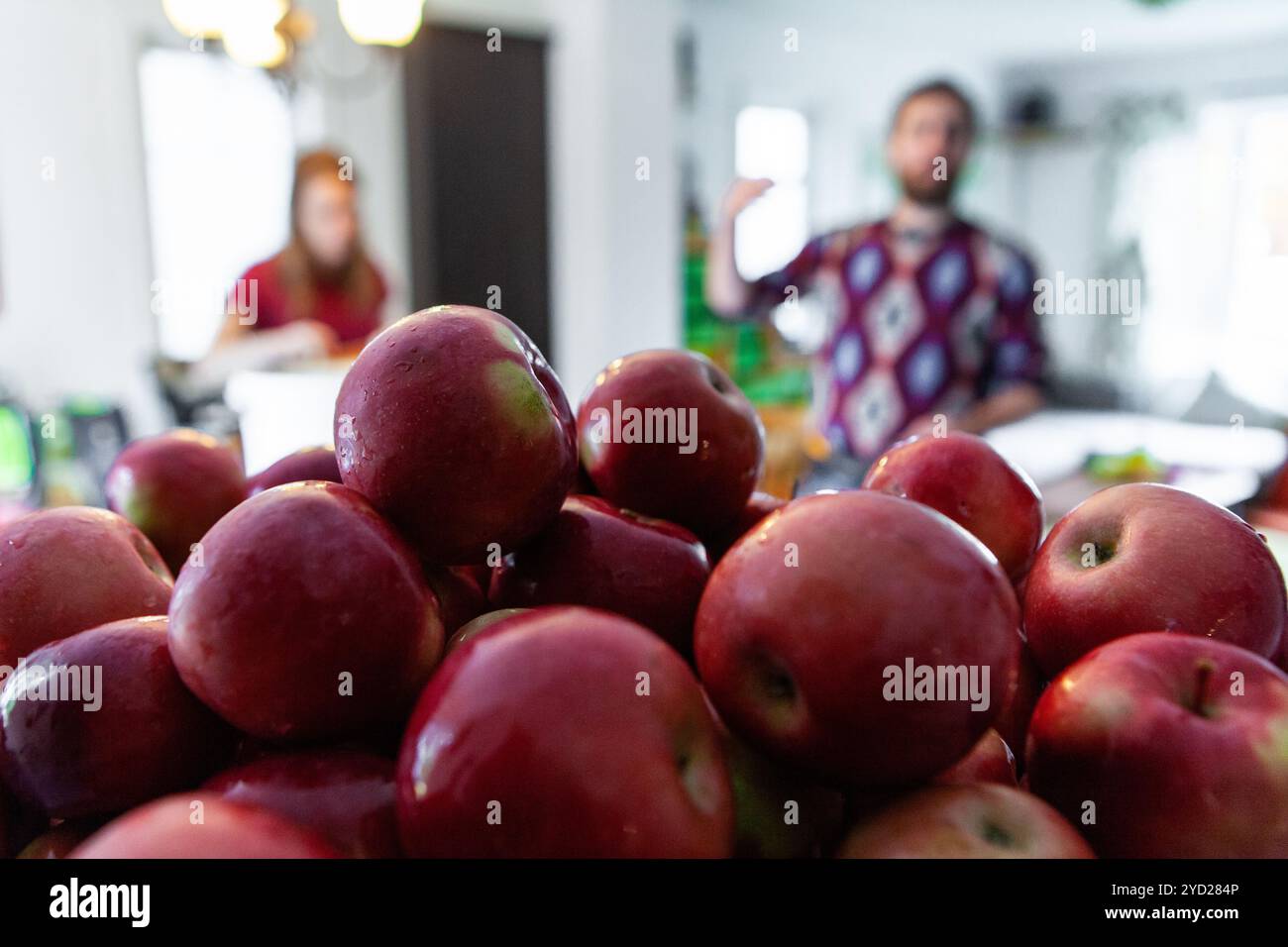 Apple pile with blurry people talking in the background Stock Photo - Alamy
