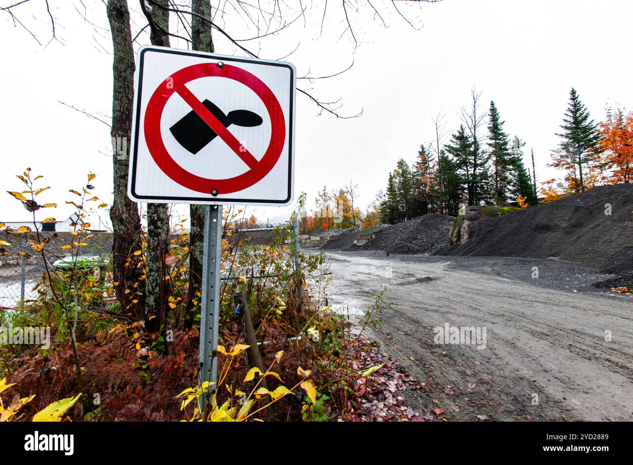 Do not litter white and red road sign in front of a construction site ...