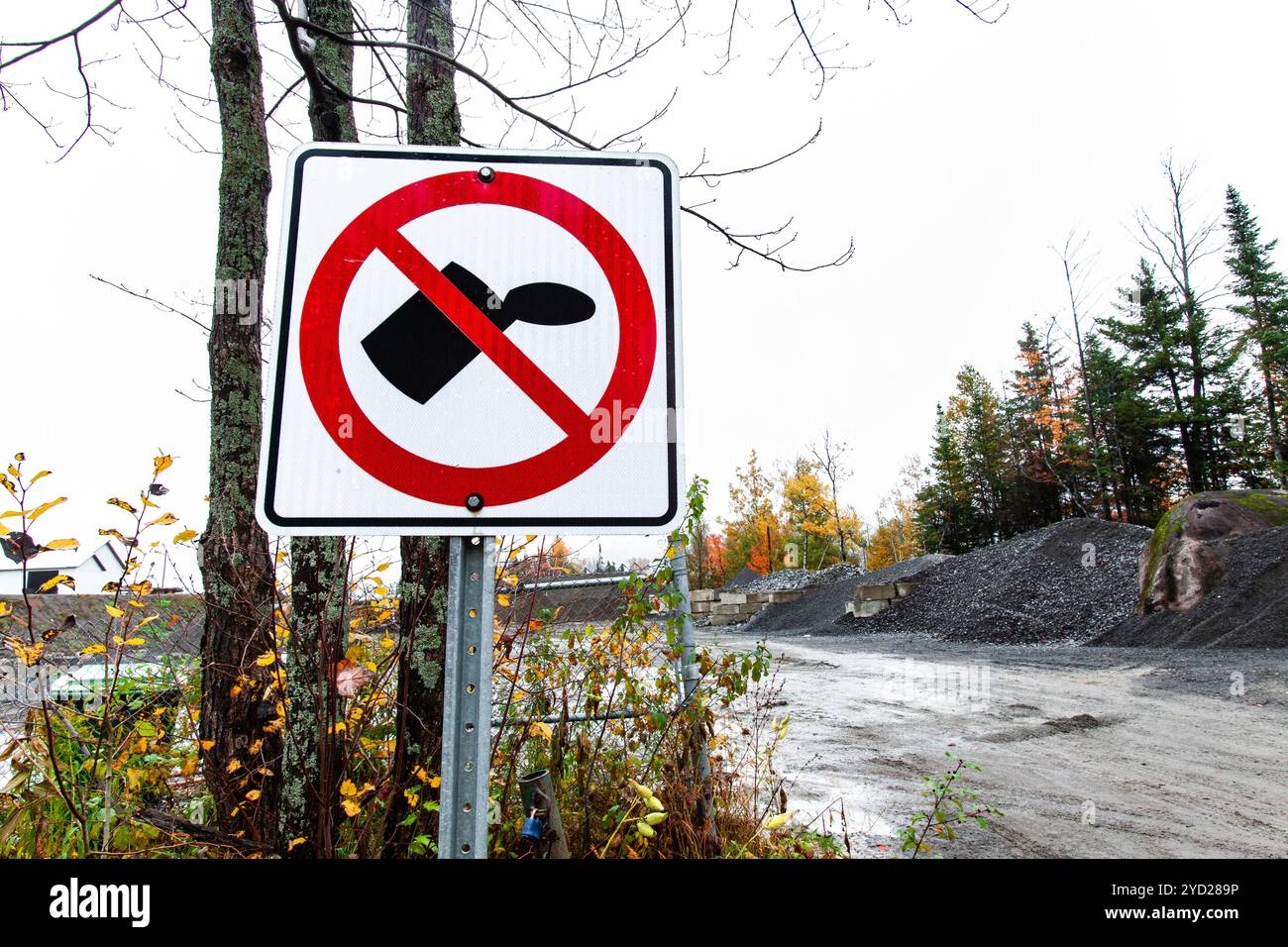 Do not litter white and red road sign in front of a construction site ...