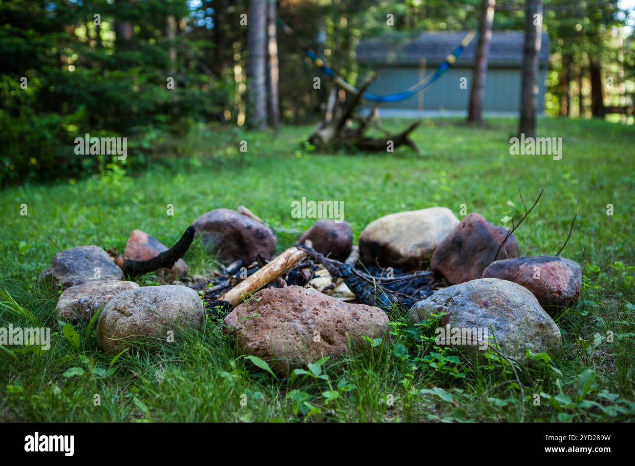 Campfire pit on green lawn Stock Photo - Alamy