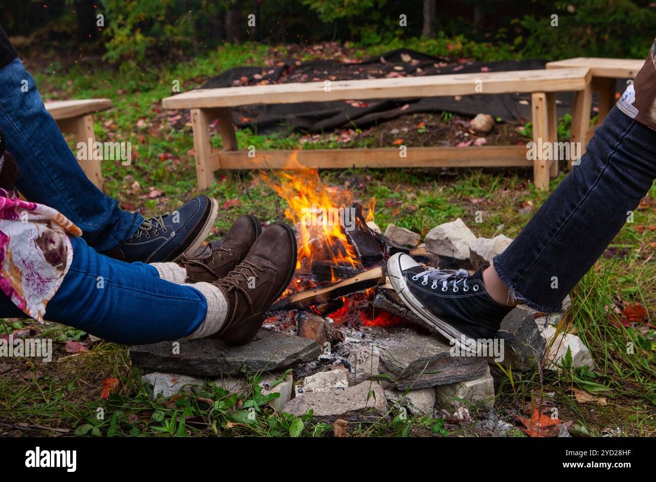 Feet around a camp fire outdoors Stock Photo - Alamy