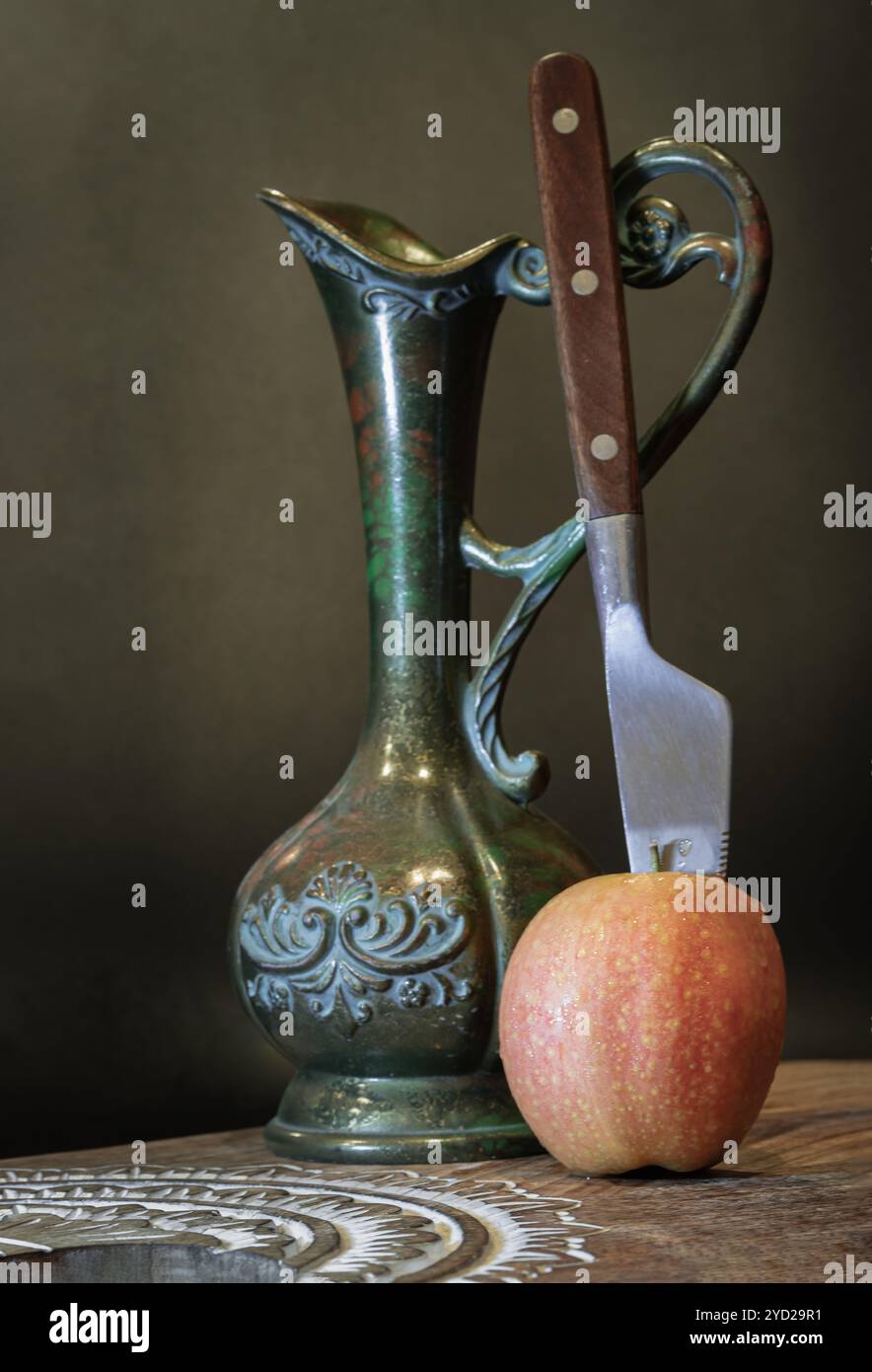 A knife is inserted into Naturally pink fresh kissabel apple fruit with ...